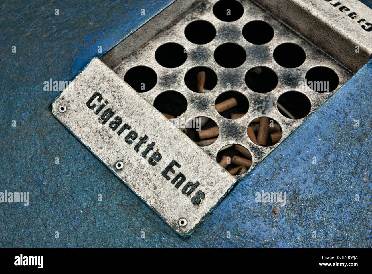 Cigarette Ends ashtray with ends visible underneath Stock Photo - Alamy