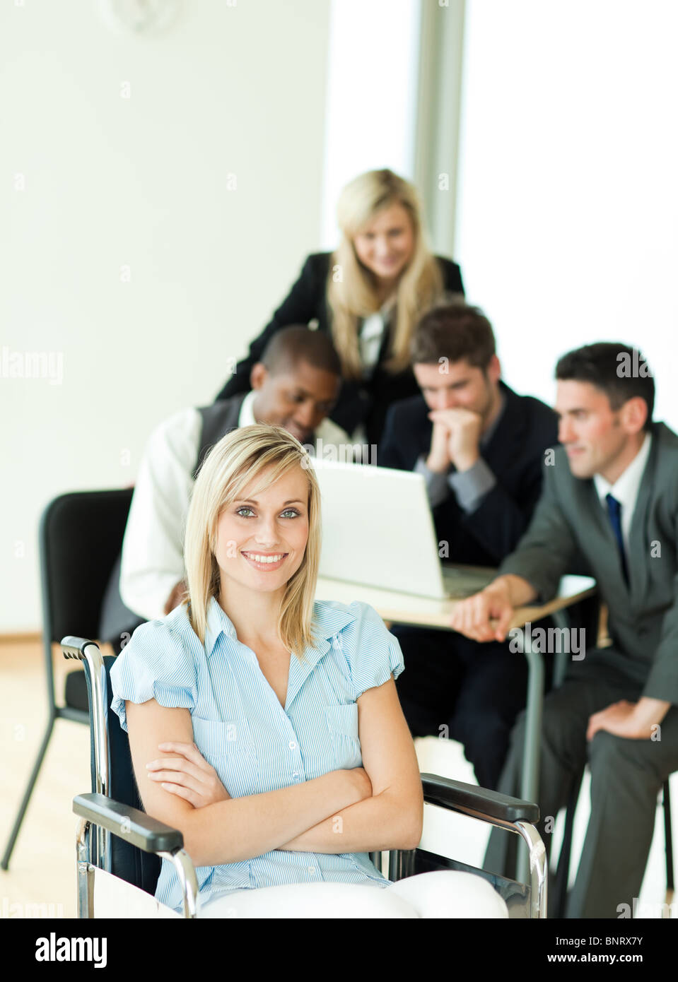 Beautiful manager with her team working in the background Stock Photo ...