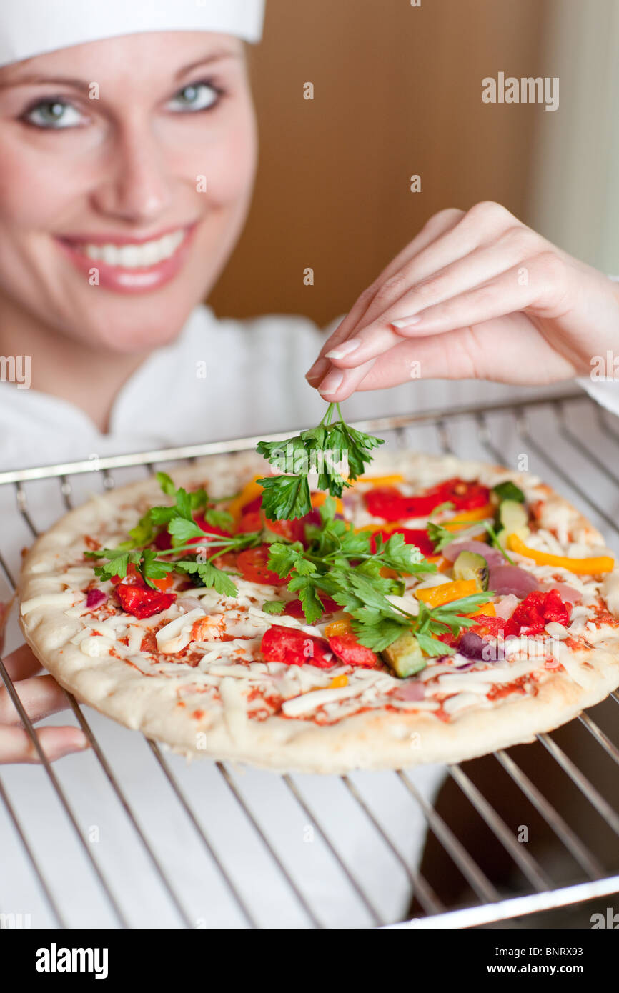 Bright female chef cooking a pizza Stock Photo - Alamy