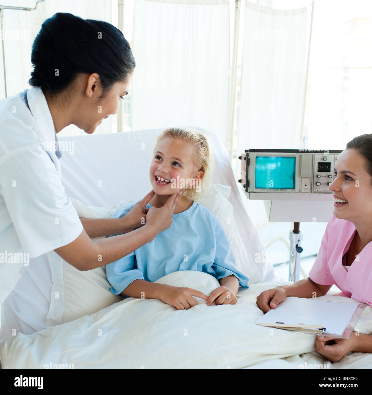 Smiling doctor attending a young patient Stock Photo - Alamy