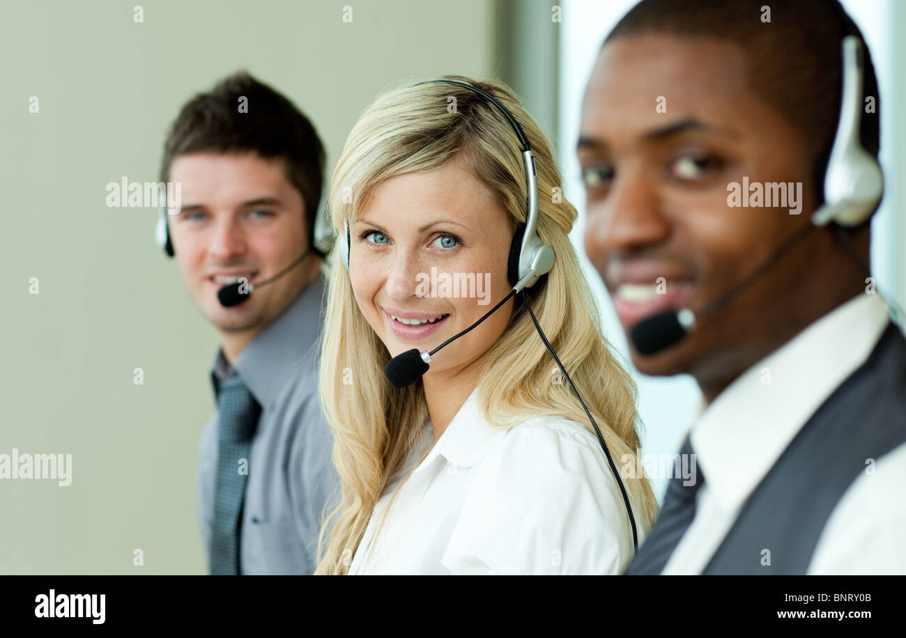 Three business people working with headsets Stock Photo - Alamy