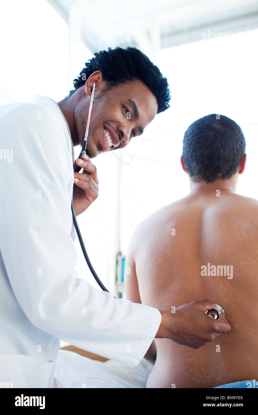Doctor attending a male patient Stock Photo - Alamy