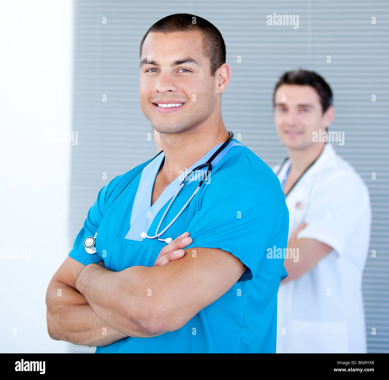 Handsome male doctor looking at the camera Stock Photo - Alamy