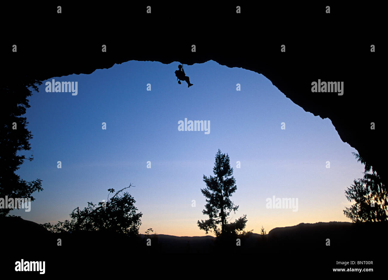 Man hanging from cliff hi-res stock photography and images - Alamy