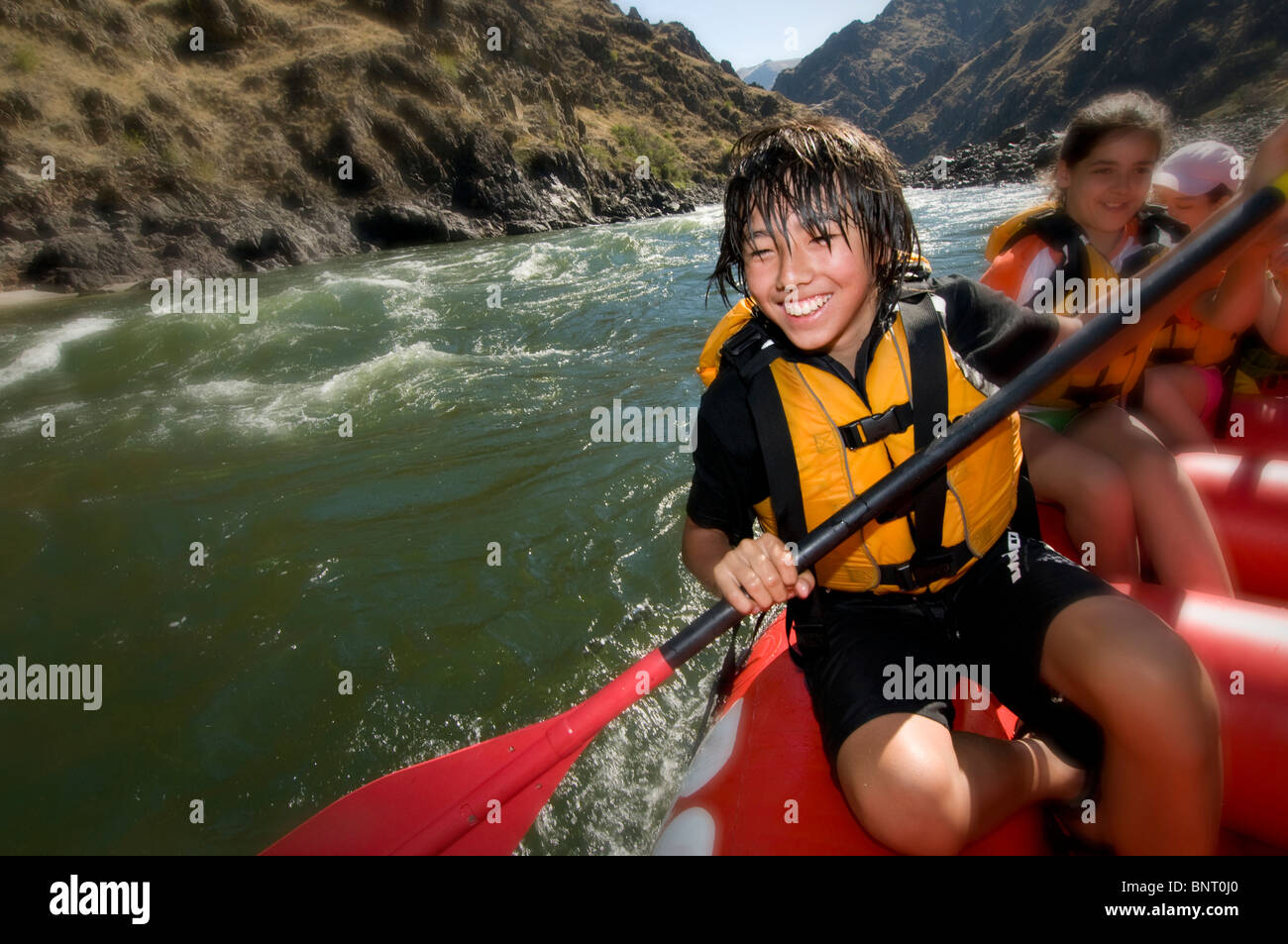 Asian American boy smiling while white water rafting Stock Photo - Alamy