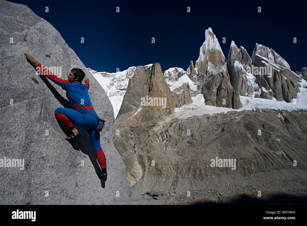 Man in Spiderman suit climbs in front mountain Stock Photo - Alamy
