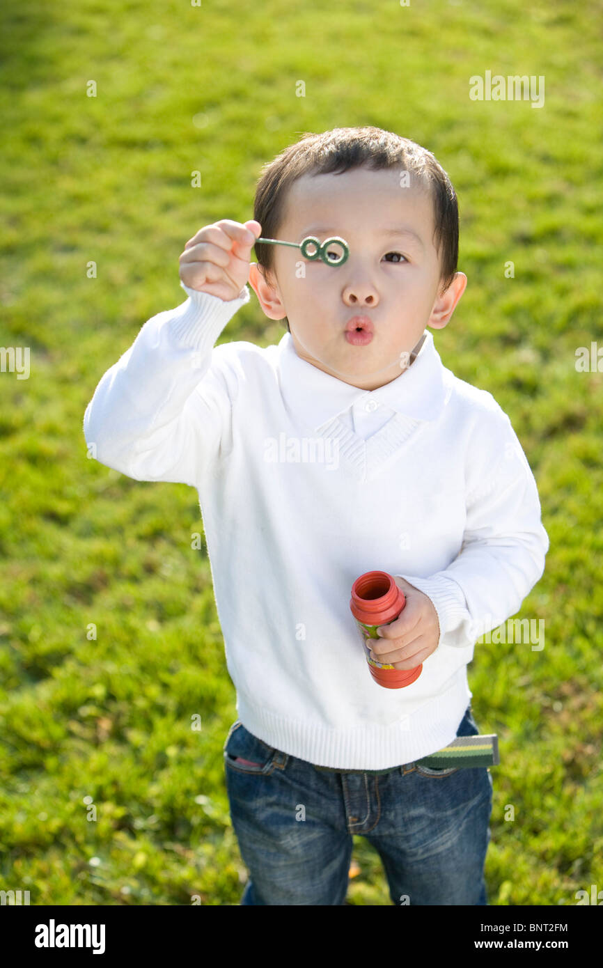 Little boy blowing bubbles Stock Photo - Alamy