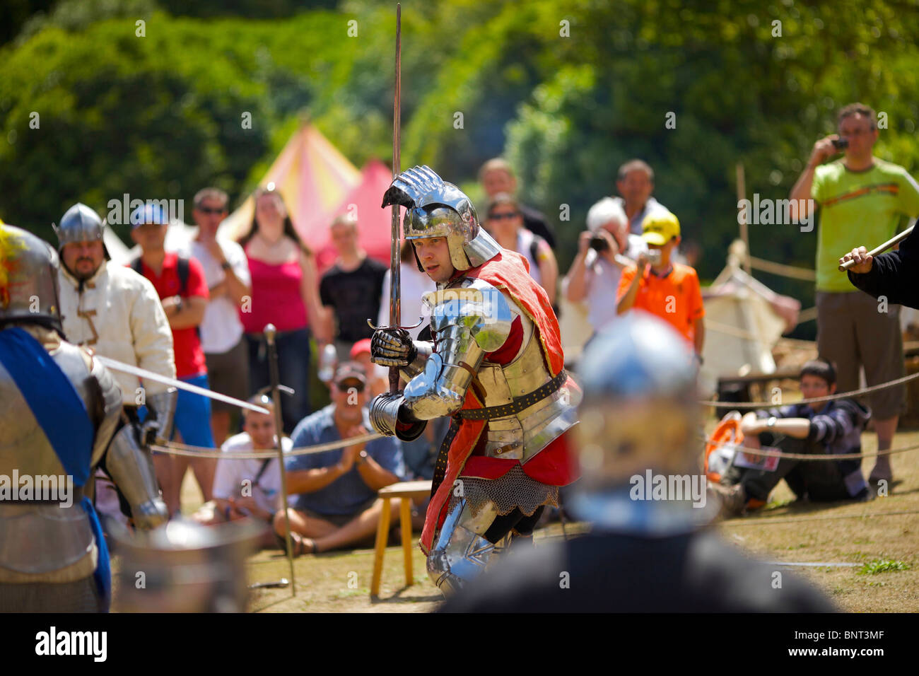 Dressed in authentic armour and using real swords re-enactors duel as ...
