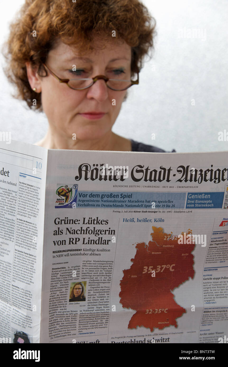 Woman reading a German newspaper Stock Photo - Alamy
