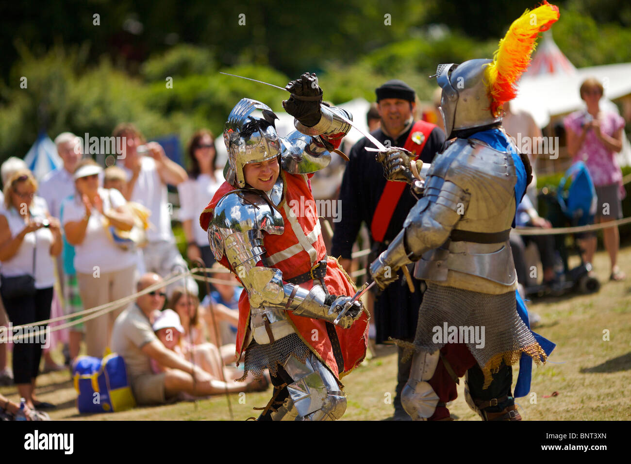 Dressed in authentic armour and using real swords re-enactors duel as ...