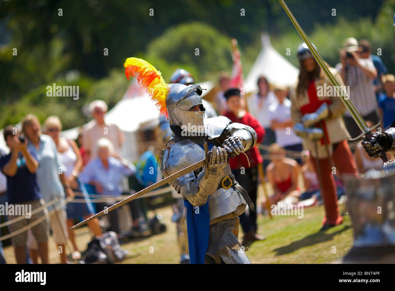 Dressed in authentic armour and using real swords re-enactors duel as ...