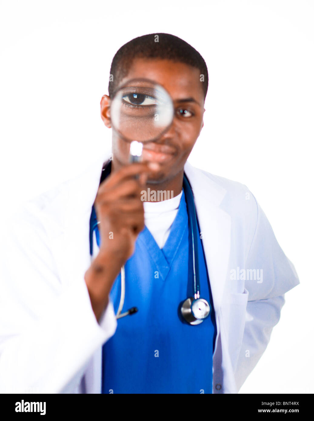 Thoughtful doctor looking through a magnifying glass Stock Photo - Alamy