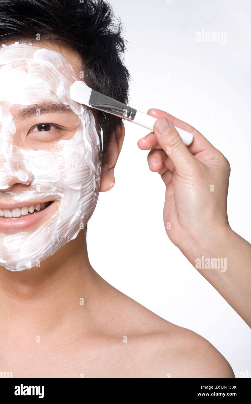 Handsome young man with facial mask Stock Photo - Alamy