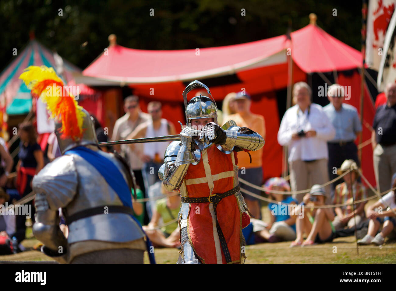 Dressed in authentic armour and using real swords re-enactors duel as ...