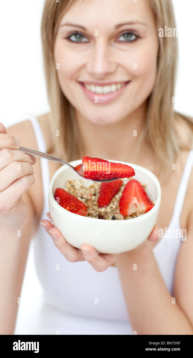 Jolly woman eating cereals with strawberries Stock Photo - Alamy