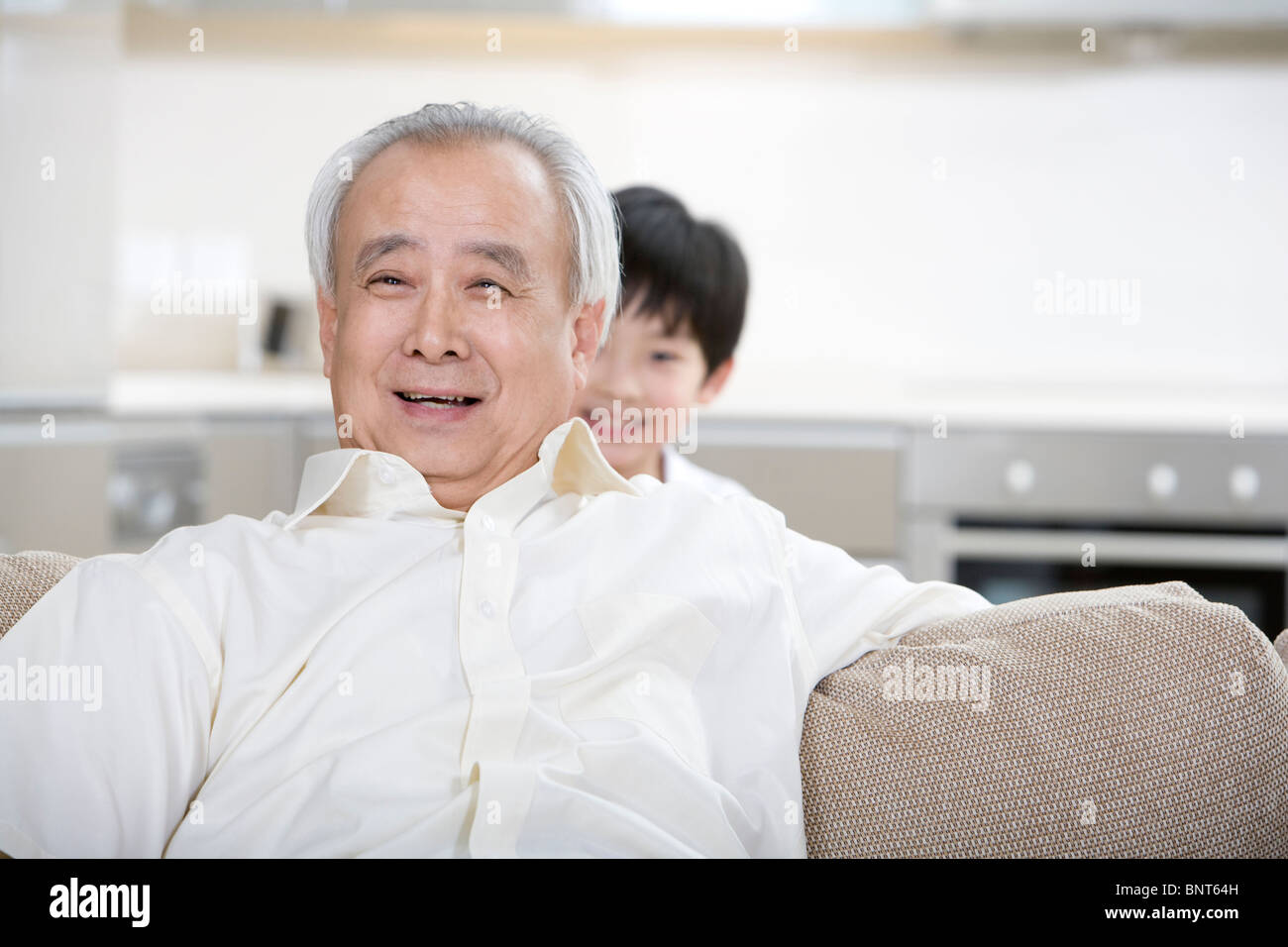Portrait of grandfather and grandson at home Stock Photo - Alamy