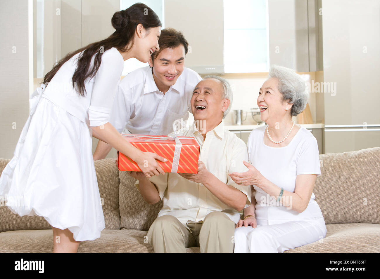 Senior man receives a gift from his family Stock Photo - Alamy