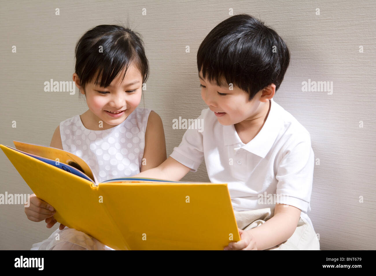 Brother and sister reading together Stock Photo - Alamy