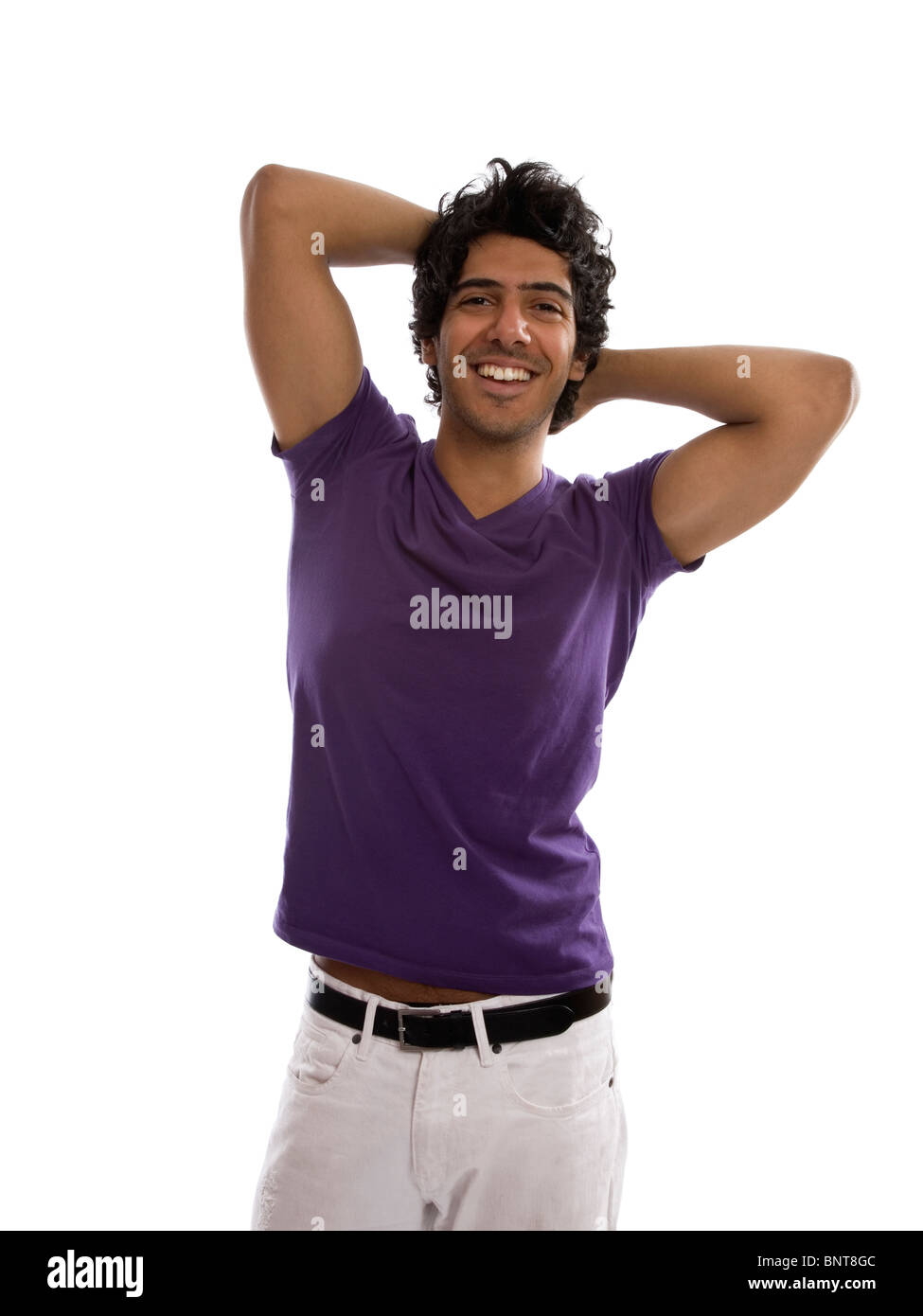 Man with purple t-shirt, arms behind head Stock Photo - Alamy