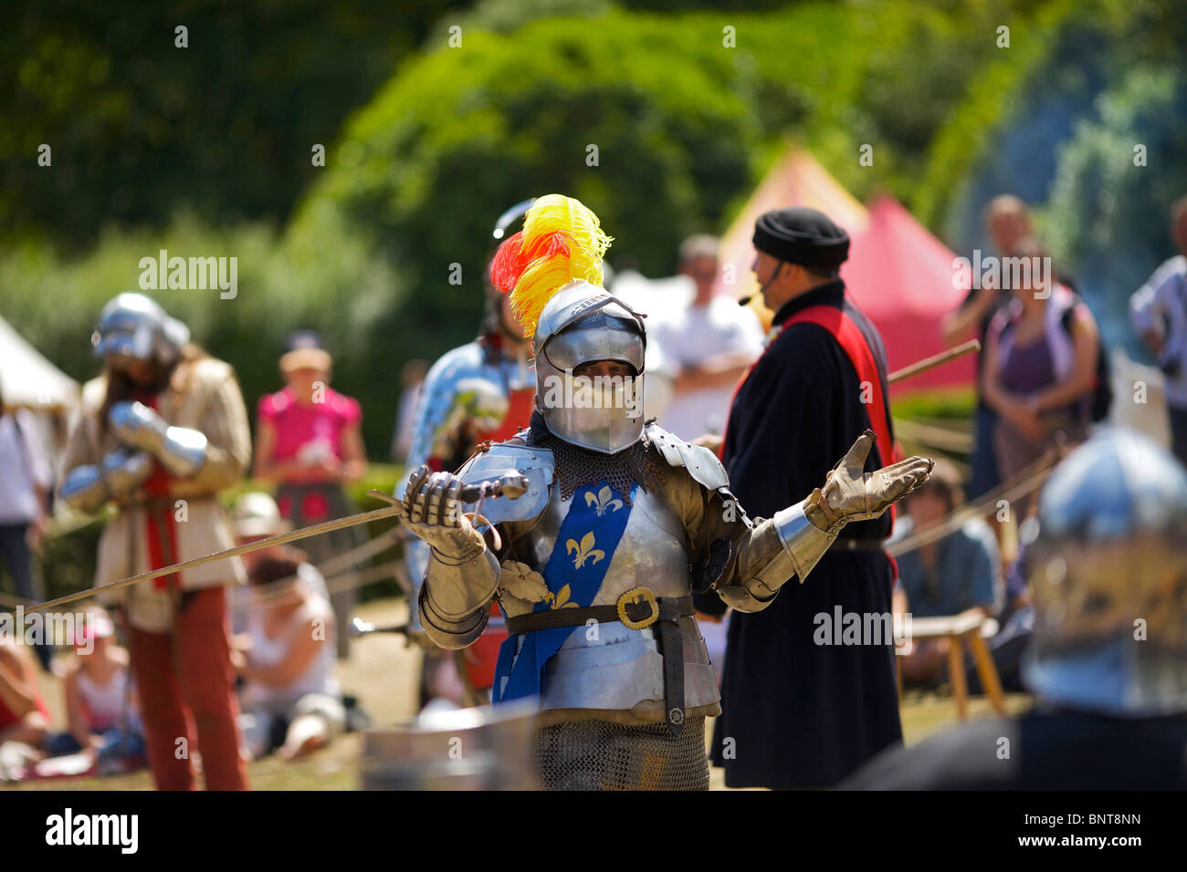 Dressed in authentic armour and using real swords re-enactors duel as ...