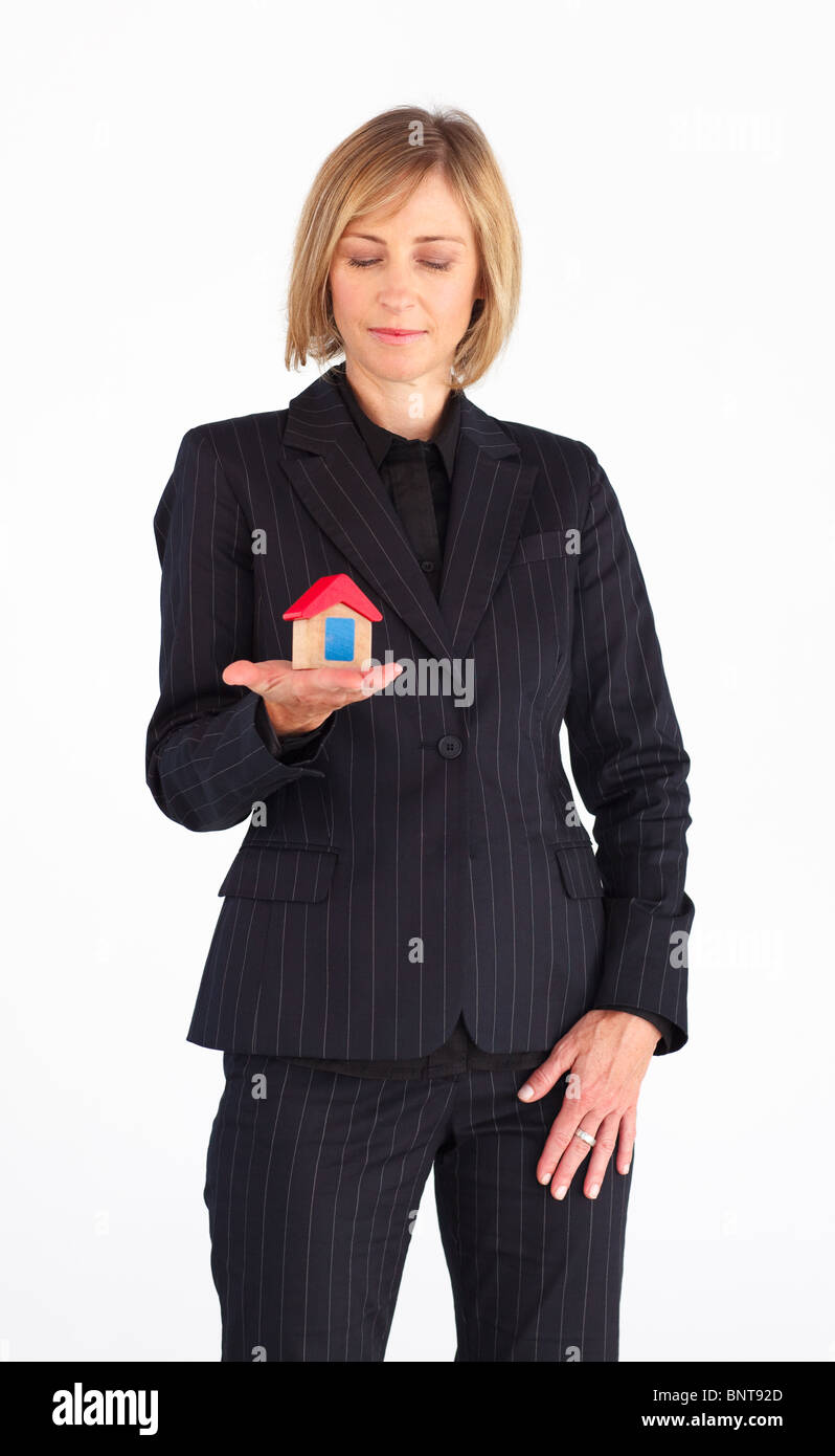 Real state agent holding a house Stock Photo - Alamy