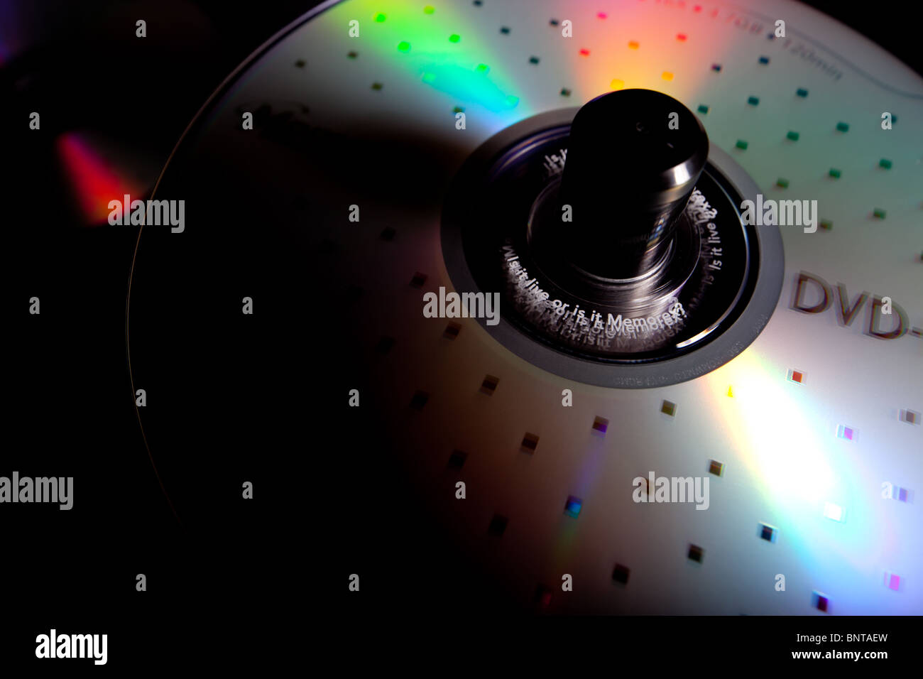 Studio image of a spindle of blank DVD's with light reflecting on the ...