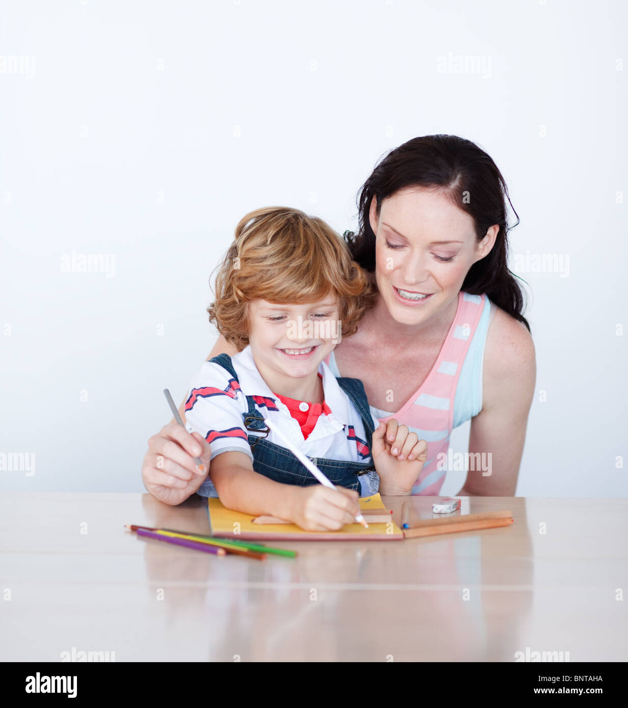 Mother and son writing together Stock Photo - Alamy