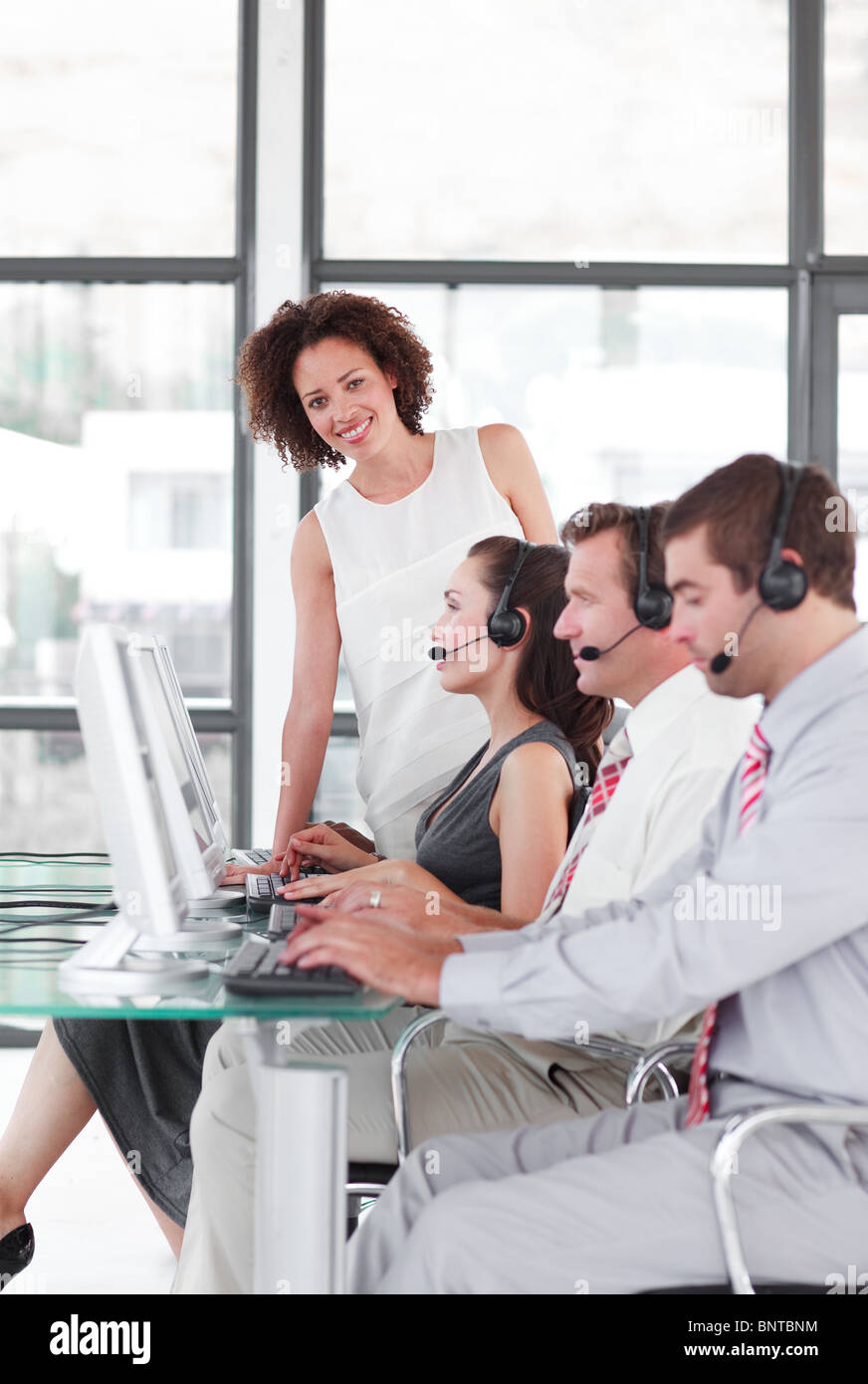 Leader managing her team in a call center Stock Photo - Alamy
