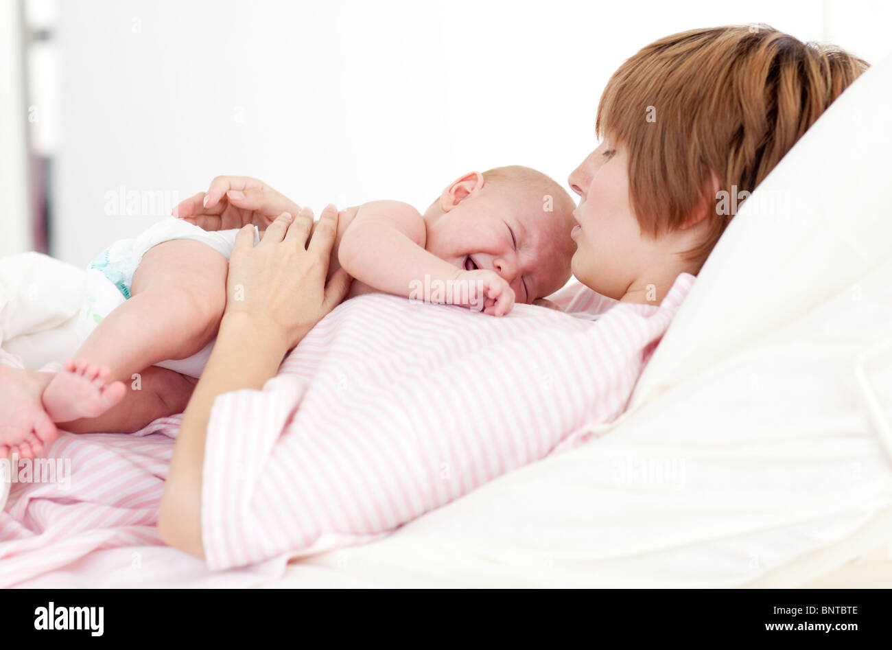 Woman holding her newborn baby Stock Photo - Alamy