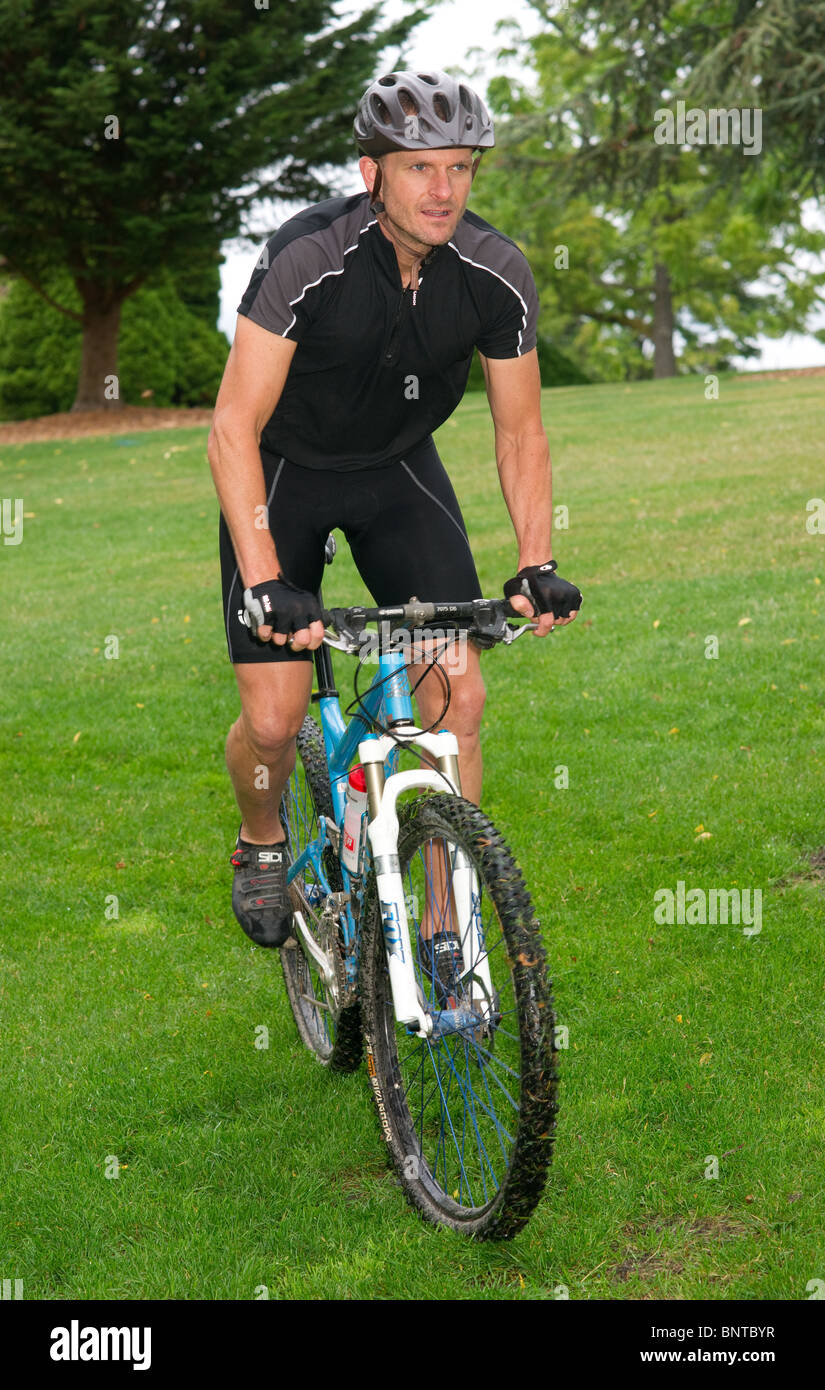 Male bike rider with his bicycle outside Stock Photo - Alamy