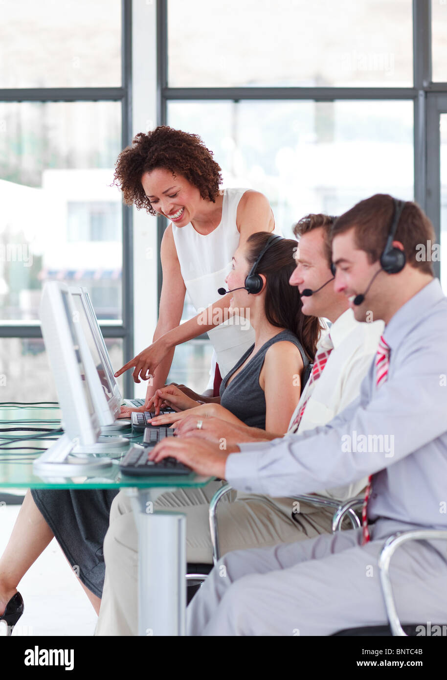 Female leader managing he team in a call center Stock Photo - Alamy