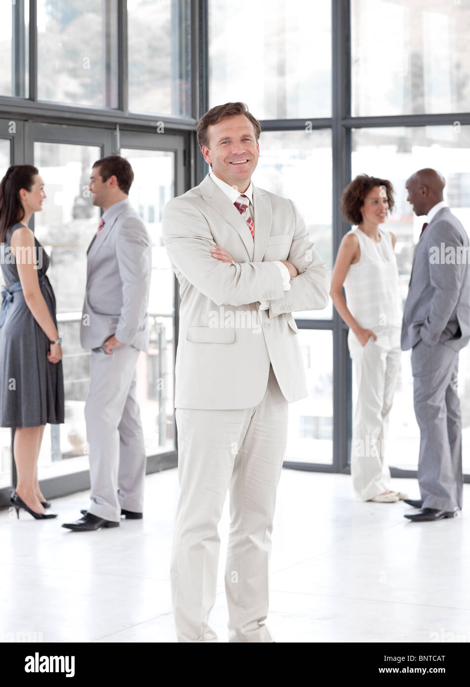 Confident male leader with his team Stock Photo - Alamy