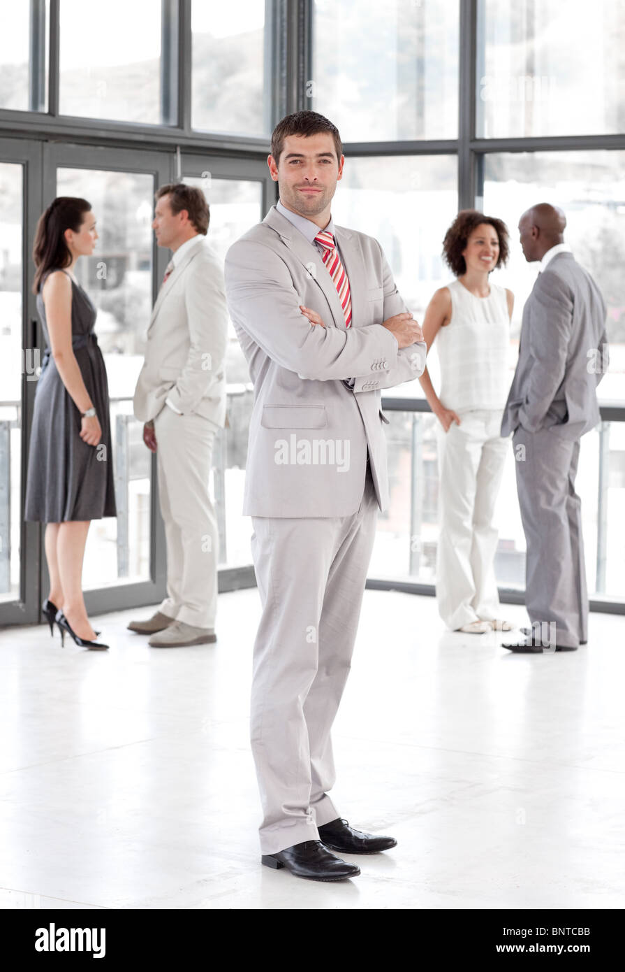Handsome male leader with his team Stock Photo - Alamy