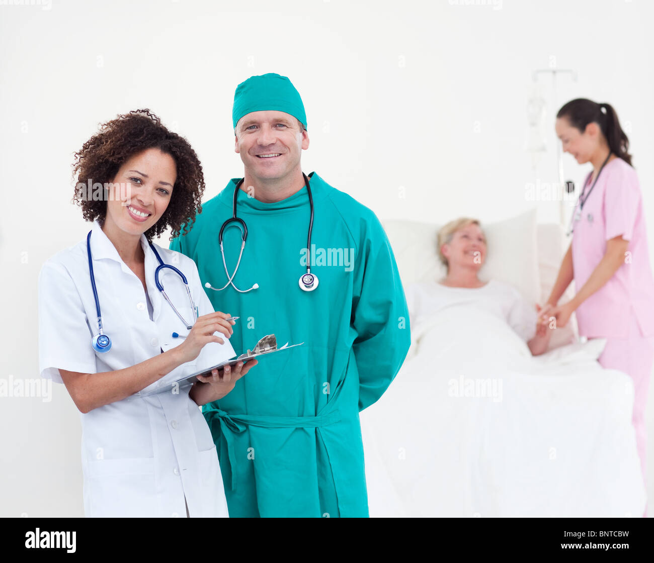 Portrait of cute doctors examining a patient Stock Photo - Alamy