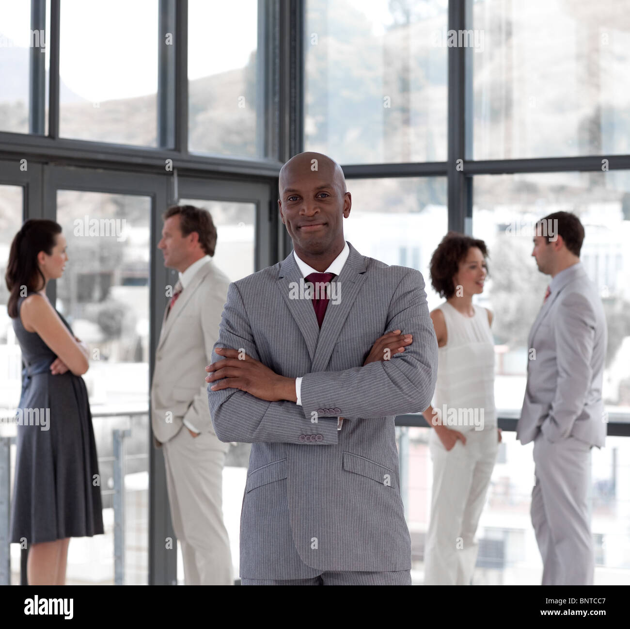 Handsome male leader with his team Stock Photo - Alamy