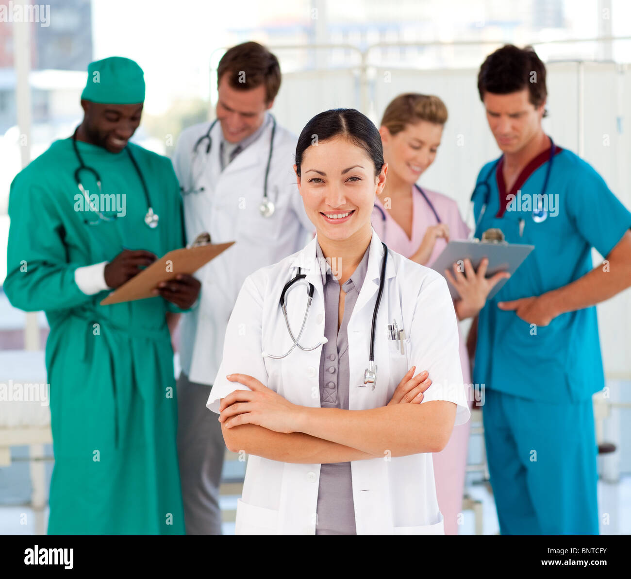 Attractive female doctor with her team Stock Photo - Alamy