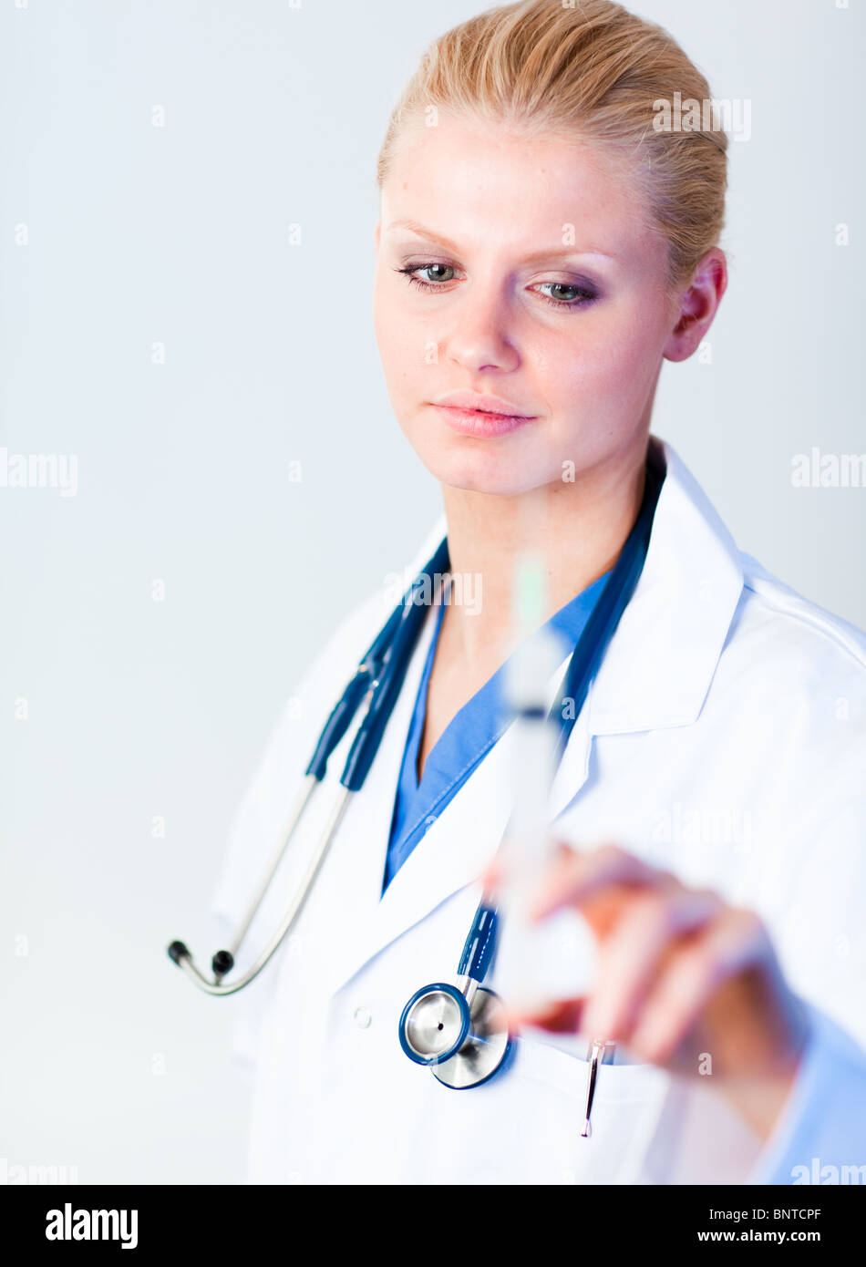 Serious Doctor holding a needle Stock Photo - Alamy