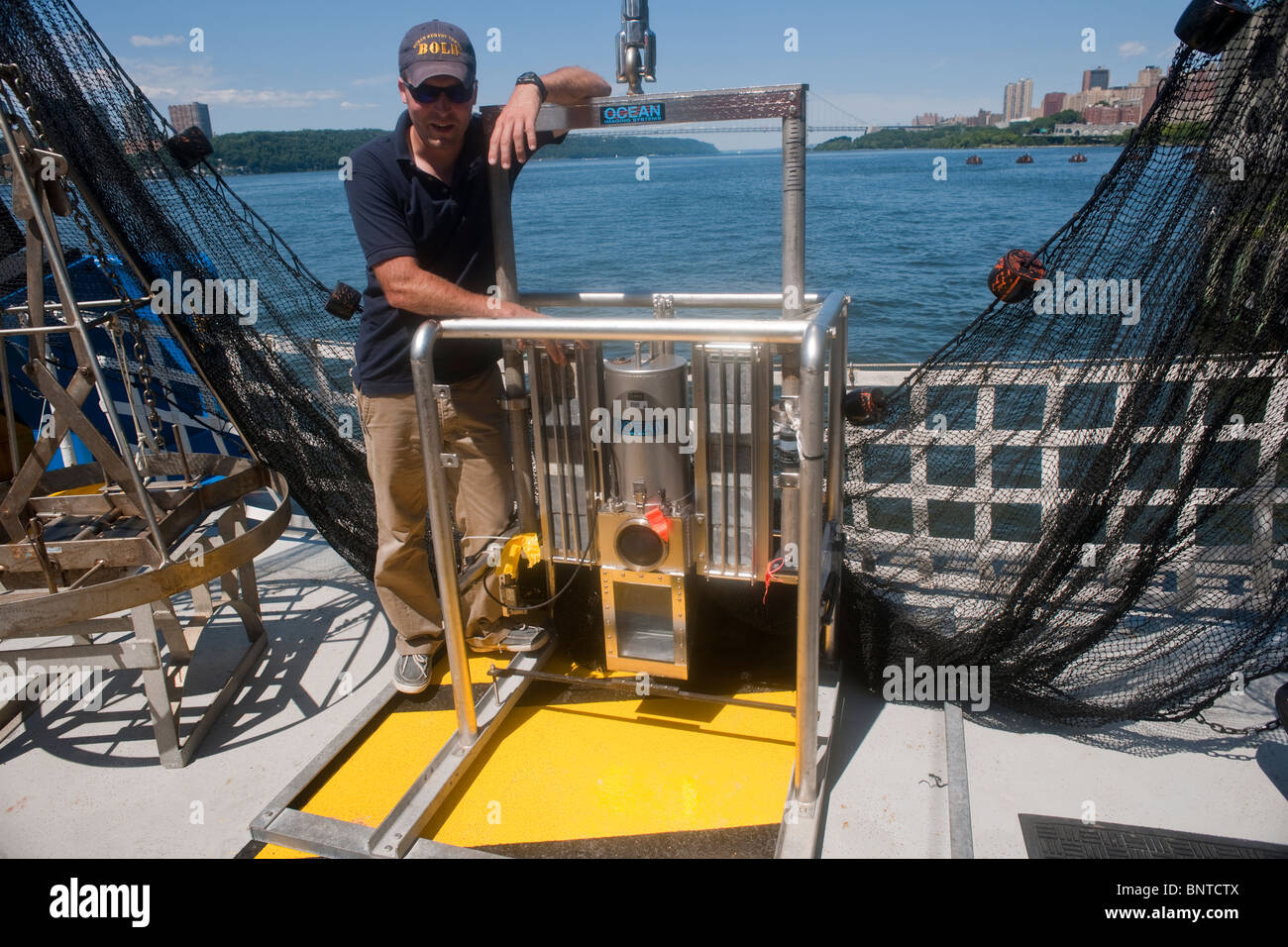 A crew member explains the underwater camera equipment aboard the ...