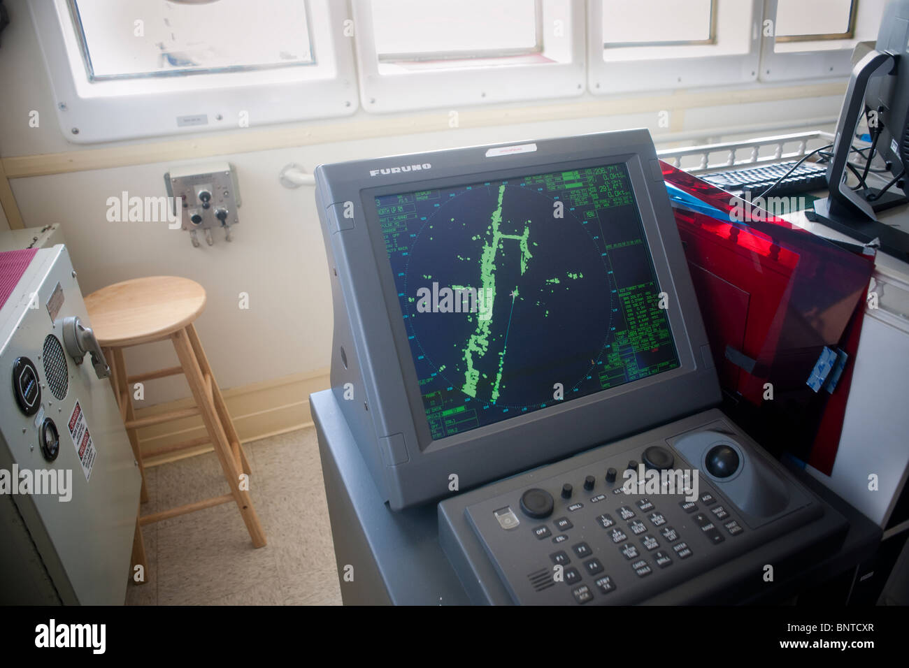 The radar station in the wheelhouse shows the location of the ship ...