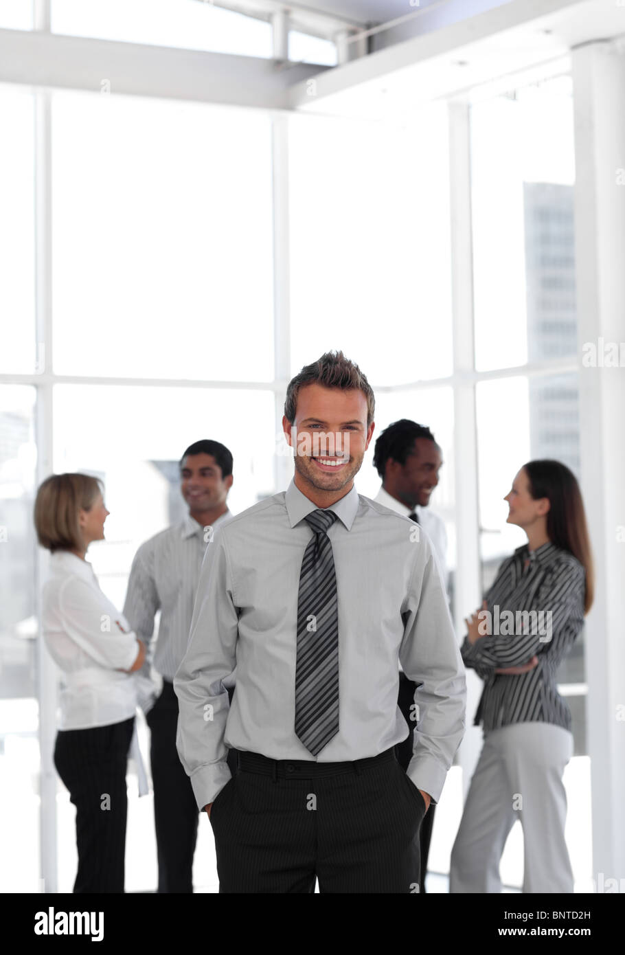 Portrait of a handsome male leader with his team Stock Photo - Alamy