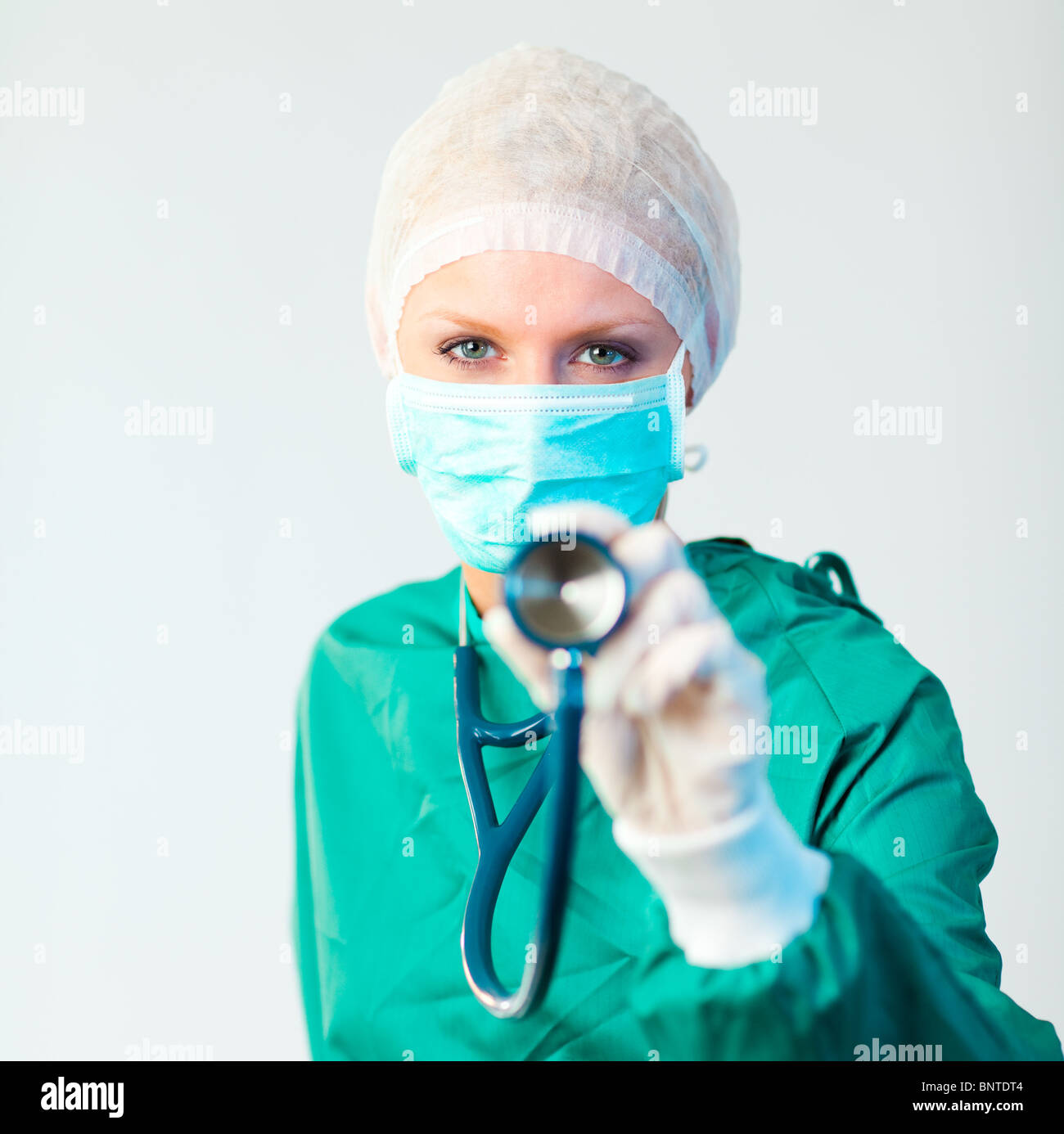 Surgeon holding stethescope outwards Stock Photo - Alamy