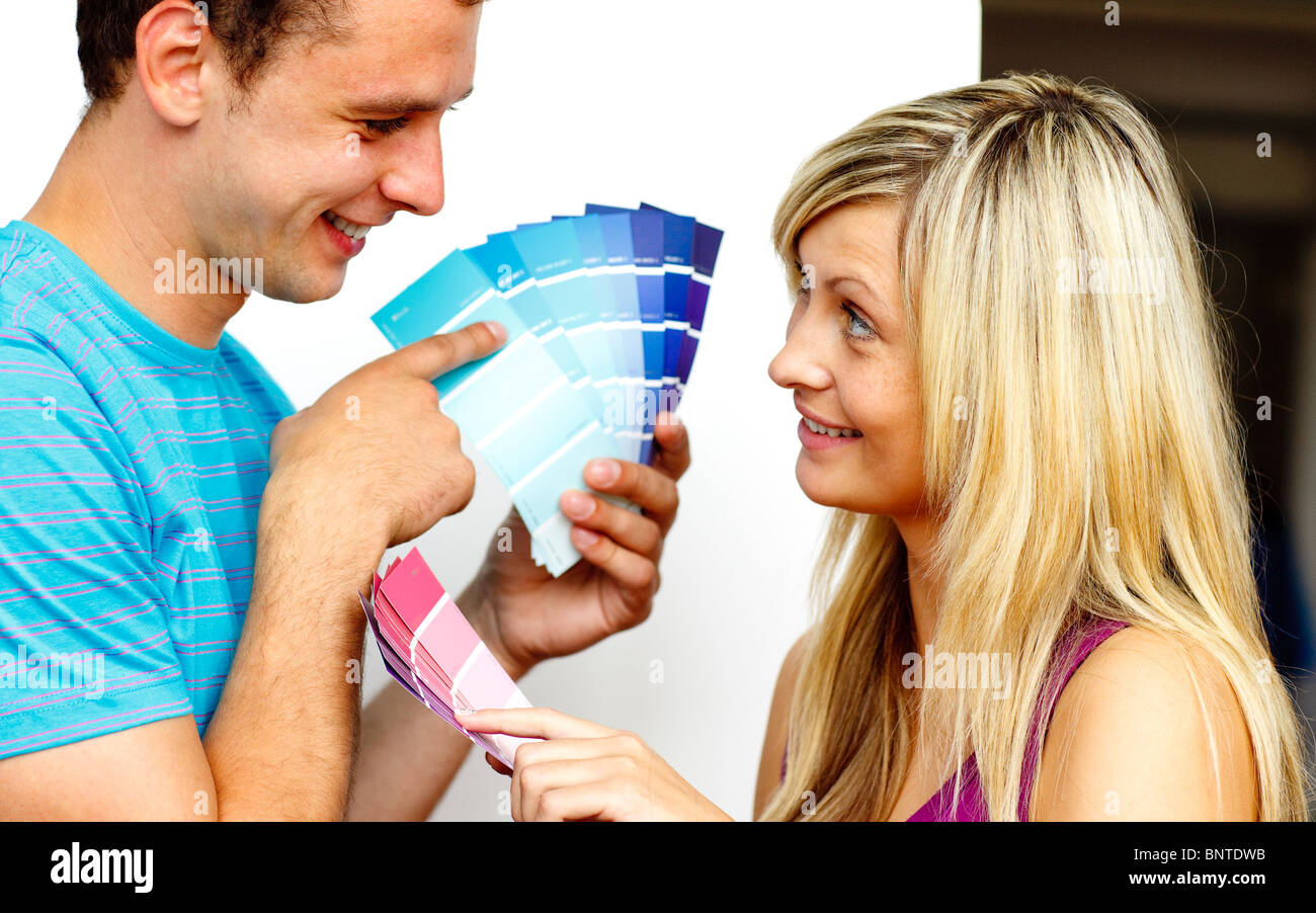 Couple chosing colours for painting house Stock Photo - Alamy