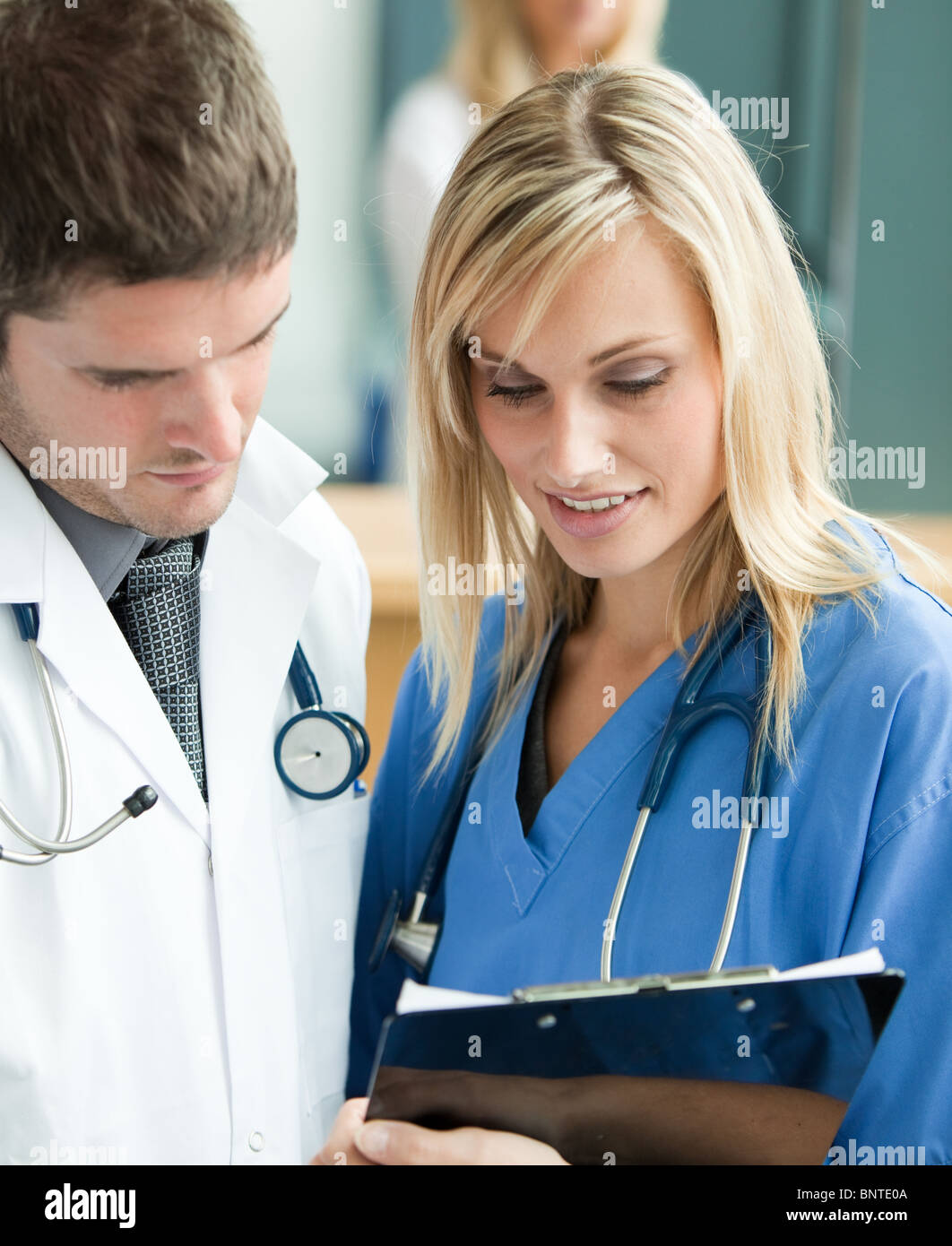 Young doctors reading a report Stock Photo - Alamy