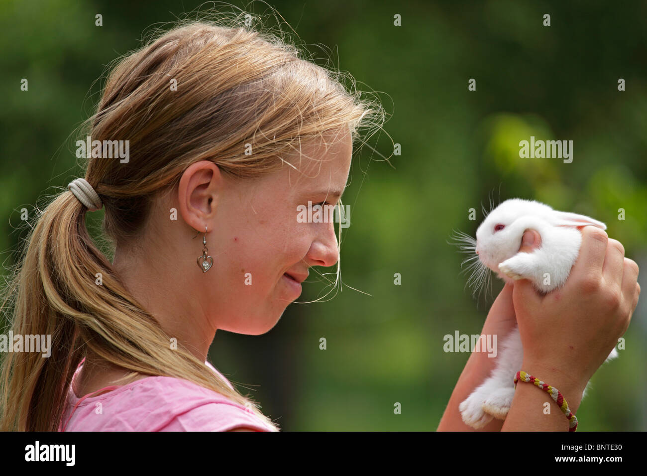 portrait of a young girl with a rabbit Stock Photo - Alamy