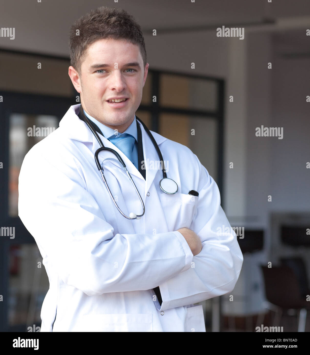 Male doctor with his arms folded Stock Photo - Alamy