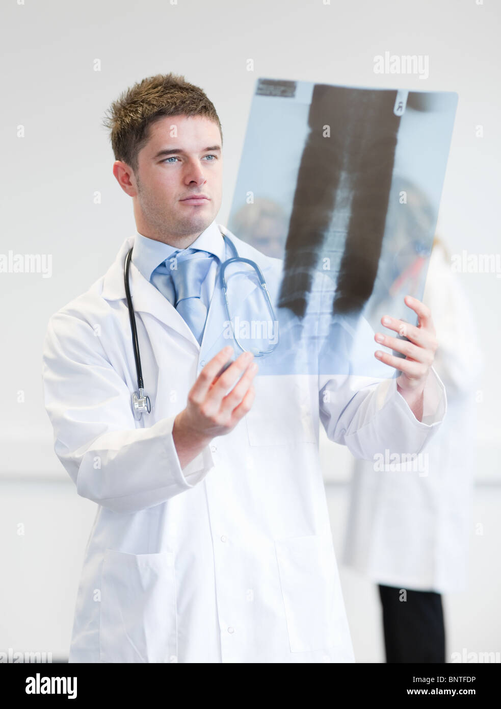 Handsome scientist looking at the x-ray Stock Photo - Alamy