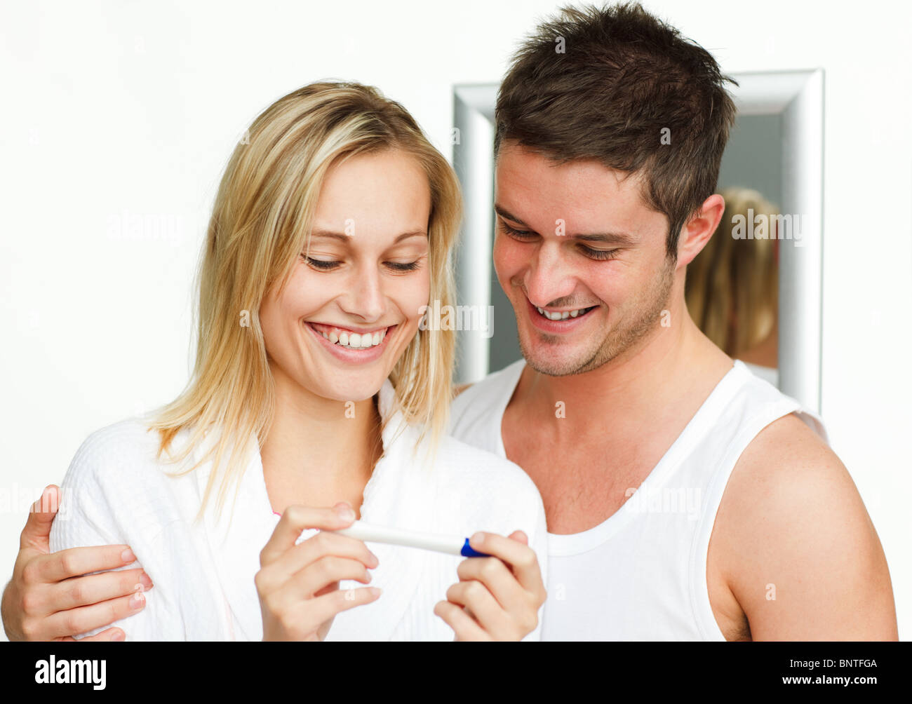 Happy couple examining a pregnancy test Stock Photo - Alamy