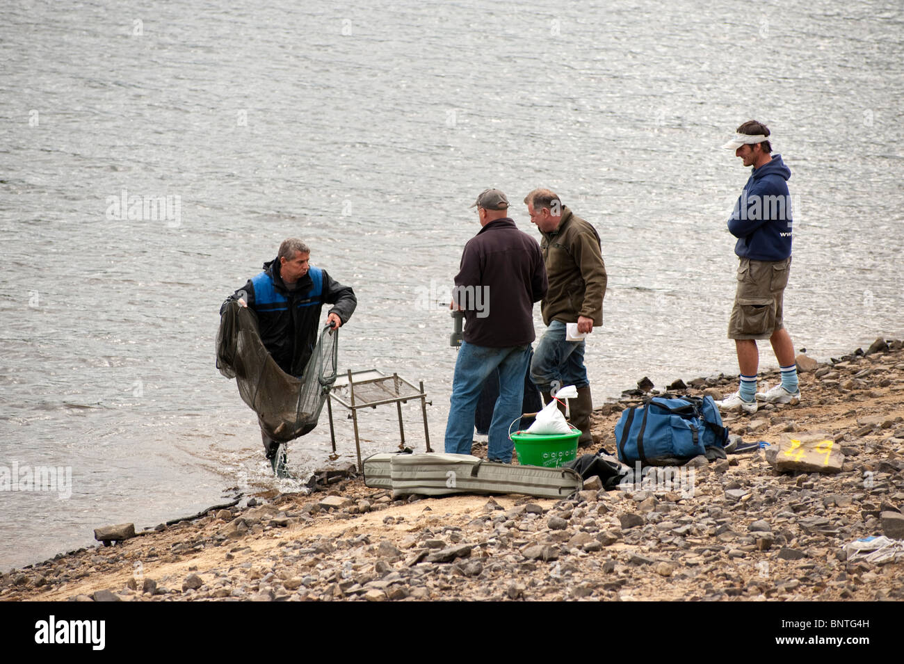Angler carrying fish in net hi-res stock photography and images - Alamy
