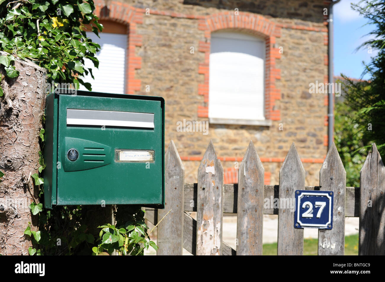 Letterbox outside brick cottage in rural village of Meneac, Brittany ...