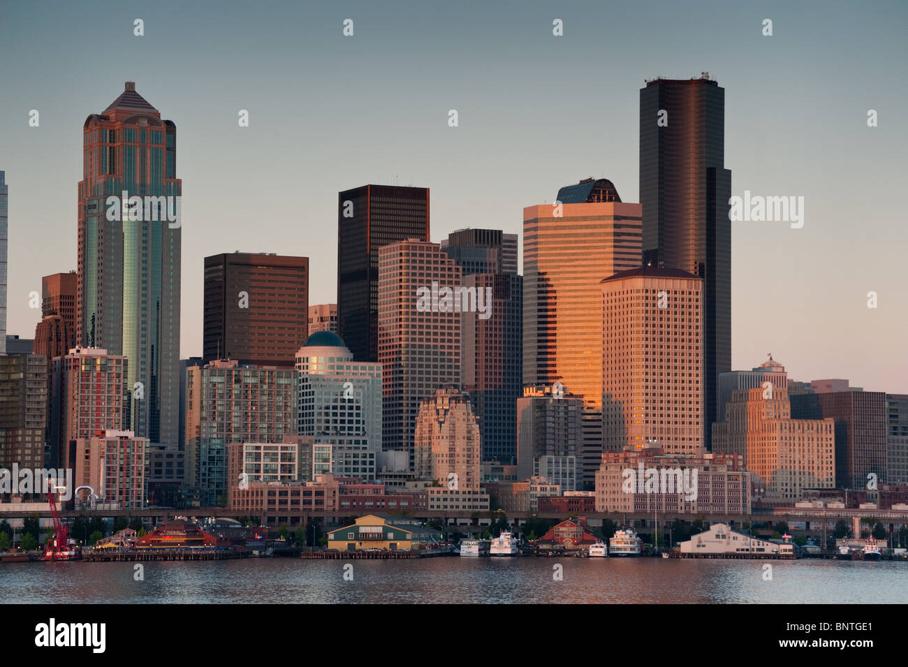 A beautiful summer sunset illuminates the Seattle skyline and the ...